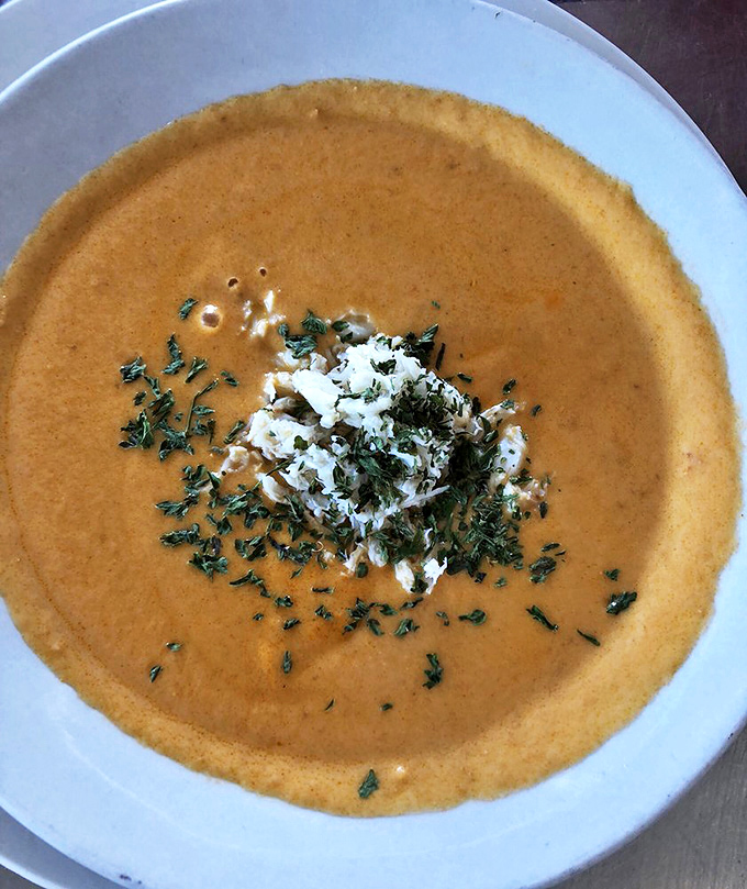 This lobster bisque isn't just soup—it's a warm, creamy hug in a bowl, garnished with fresh herbs and a story.