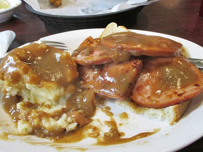 Ham and mashed potatoes swimming in gravy—a plate that whispers, "Diet starts tomorrow." This is what comfort food looked like before Instagram made it fancy.