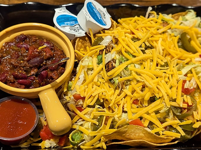 Nachos that require a topographical map to navigate—a mountain range of cheese, valleys of salsa, and peaks of jalapeños.