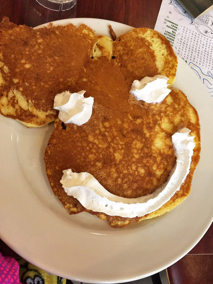 The Mickey Mouse pancake with whipped cream smile—proving that playing with your food is sometimes exactly what the soul needs.