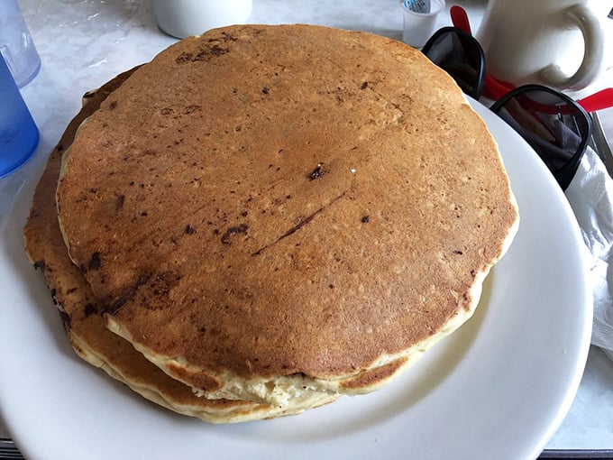 These aren't just pancakes—they're fluffy golden discs of happiness that make you forget about your diet faster than you can say "maple syrup."