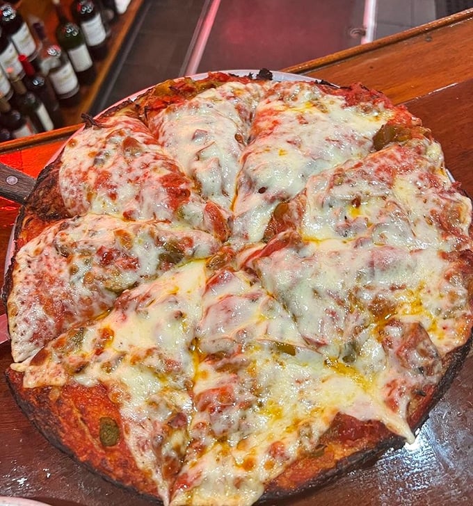 This isn't Instagram pizza; it's the real deal—bubbling cheese, substantial crust, and that sauce that haunts your dreams.