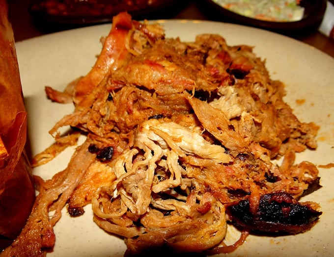 Pulled pork in its natural habitat—a beautiful tangle of bark-flecked strands that have clearly been introduced to smoke and time in equal measure.