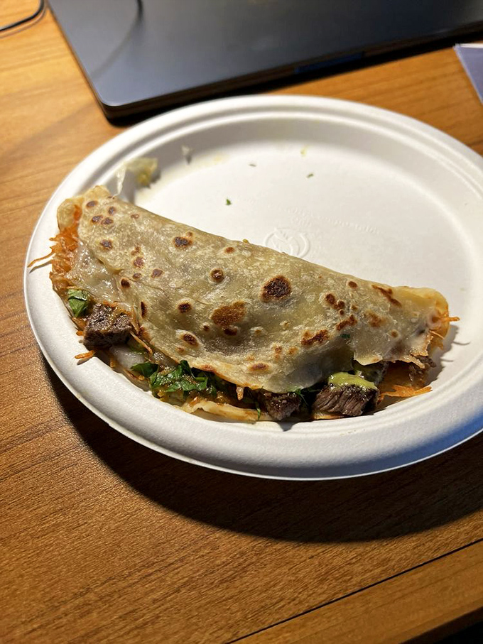 The humble quesadilla, elevated to art form—crispy, cheese-laden edges giving way to a tender center filled with savory treasures.