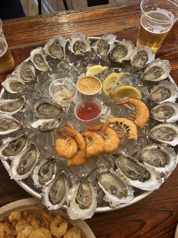 A platter of oysters so fresh they practically whisper tales of the tides they rode in on, served with cold beer—nature's perfect pairing.