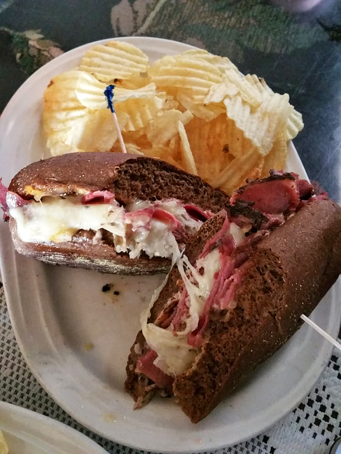 This isn't just a sandwich; it's an engineering marvel of melted cheese, stacked meat, and pumpernickel precision that demands a two-handed commitment.