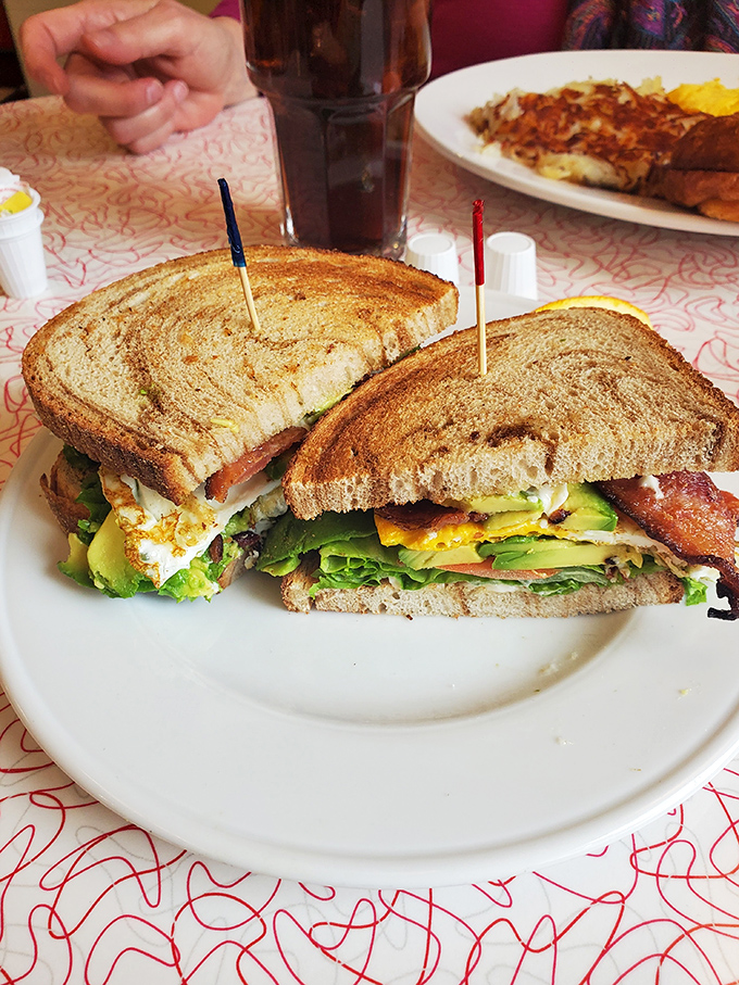 This isn't just a sandwich—it's an architectural marvel of crispy toast, fresh veggies, and layers that would make a geologist jealous.