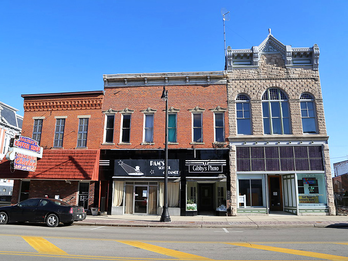 Main Street's architectural personality disorder – brick, stone, and history all competing for your attention while somehow creating a harmonious small-town symphony.