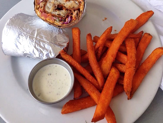 Sweet potato fries that achieve the impossible: crispy exterior, pillowy interior, and a dipping sauce worth writing home about.