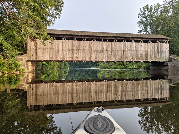 Mirror, mirror on the water—the bridge's perfect reflection doubles the visual delight, creating a photographer's dream from the river perspective.
