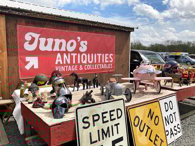 Juno's Antiquities beckons with vintage treasures and road signs that once guided travelers before GPS told us to "make a U-turn."