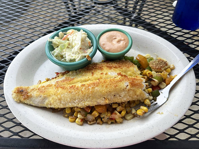 This cornmeal-crusted walleye isn't just fish—it's a Midwest handshake on a plate, served with vegetables that actually taste like vegetables.