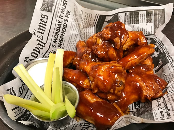 These wings aren't just sauced—they're baptized in tangy, sticky glory. Served newspaper-style with crisp celery soldiers standing at attention, ready for their cooling ranch dip mission.