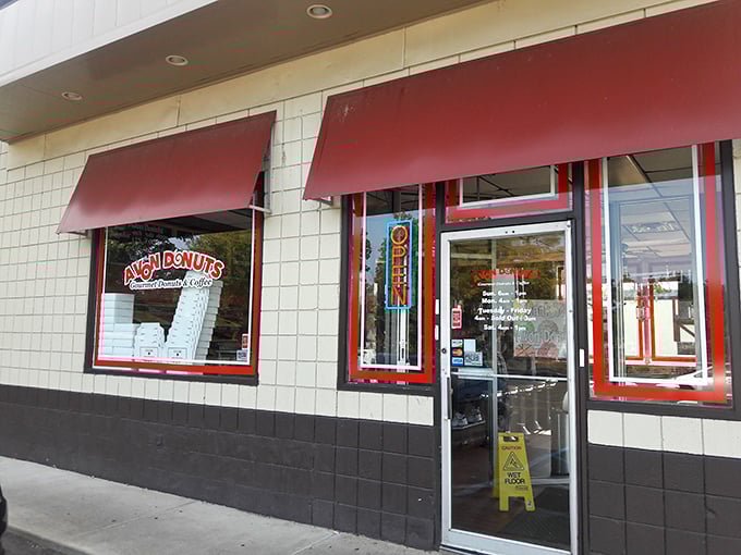 Avon Donuts' clean white exterior with red accents is like the business suit of donut shops – professional on the outside, party on the inside.
