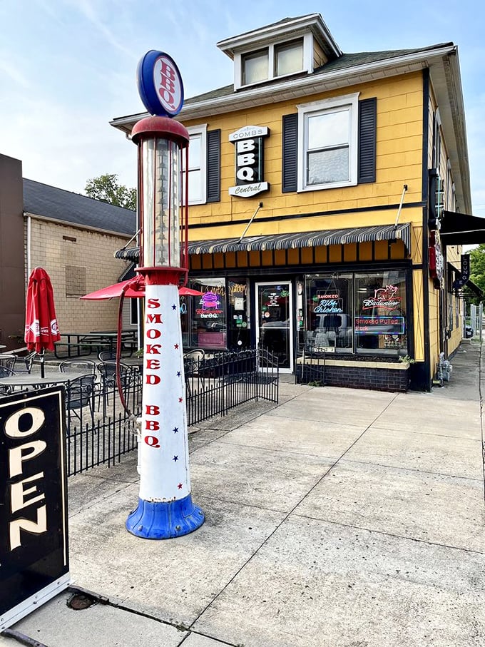 That vintage gas pump isn't pumping gas – it's pumping pure barbecue excitement outside this cheerful yellow house!