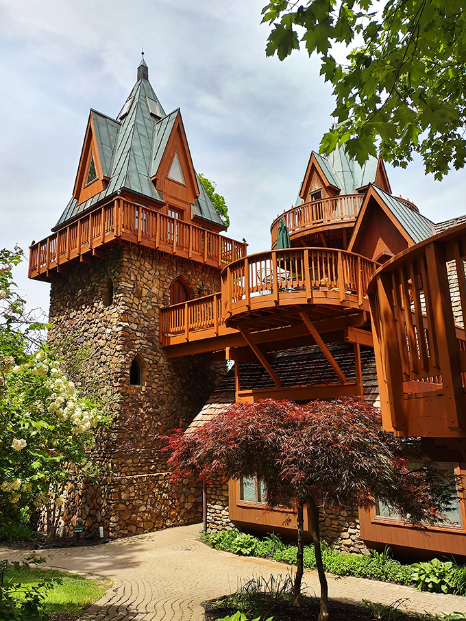 Wooden balconies and stone towers emerge from the forest. Sleeping Beauty would approve of this hideaway.