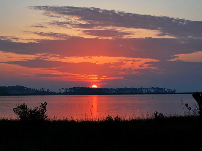 Quiet waters reflecting dramatic skies – the kind of sunset that makes you stop mid-conversation and just stare.