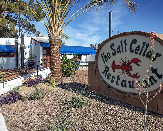 The Salt Cellar's unassuming entrance hides an underground treasure. That palm tree stands sentinel over seafood secrets below.