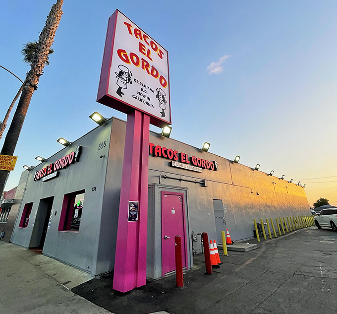 Tacos El Gordo's unmistakable pink signage stands out like a neon beacon for Tijuana-style taco perfection. You can't miss it—and you shouldn't!