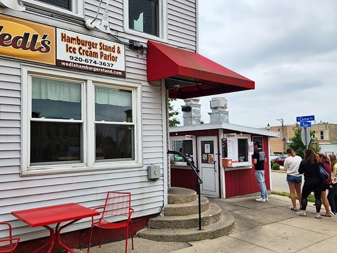 Wedl's tiny red burger stand proves that greatness often comes in small packages—especially when those packages contain perfectly grilled sliders with onions.