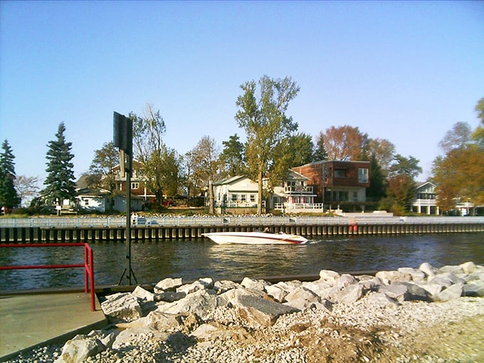 With a hint of fall in the trees and a boat gliding by, South Haven’s harbor holds onto the season’s last golden days.