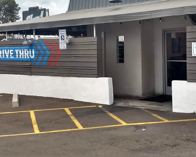 This drive-thru window at The Stand has witnessed countless moments of burger-induced joy. Simple building, extraordinary flavors.
