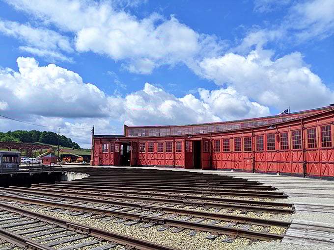 The vibrant red Age of Steam Roundhouse stands like a time machine to railroading's golden era. Even the clouds showed up to appreciate this slice of history.