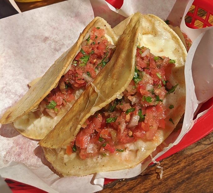 These tacos aren't just food; they're edible art. Fresh pico de gallo cascades over melted cheese, creating a flavor fiesta in every bite.