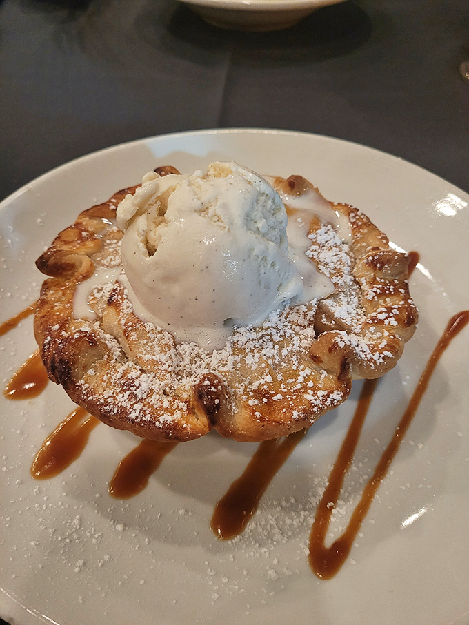 This isn't just dessert—it's therapy on a plate. Warm apple pastry crowned with vanilla ice cream melting into caramel rivers.