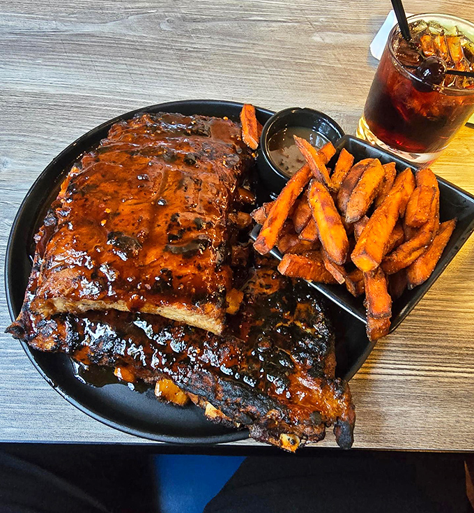 These ribs don't just fall off the bone—they practically leap toward your mouth, glistening with sauce that deserves its own fan club.