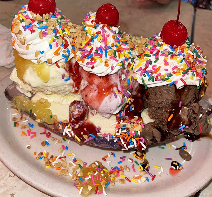 The famous banana split in all its glory—where sprinkles rain down like confetti at a dessert parade.