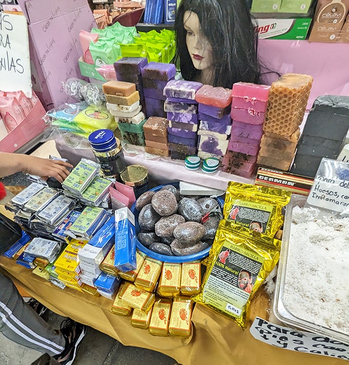 Beauty products arranged with the precision of an art installation. That mannequin head seems to be judging your skincare routine from her soap-scented throne.