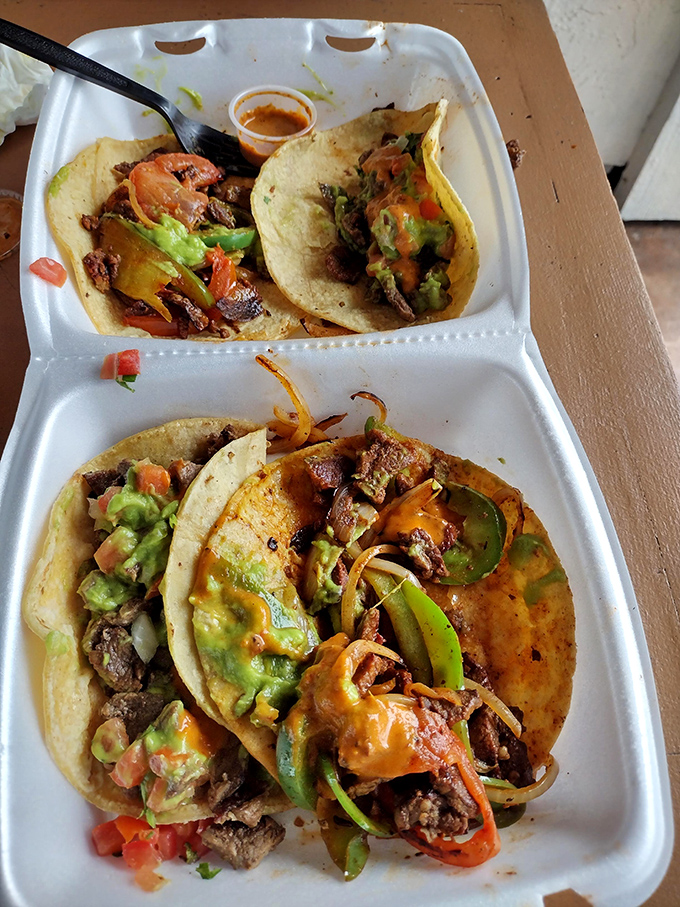 These street tacos aren't just served—they're presented with pride. The splash of color from guacamole and pico de gallo is nature's perfect garnish.