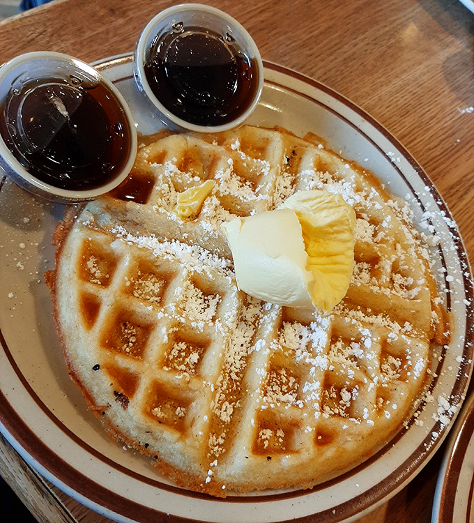 Waffles with the perfect grid pattern—nature's way of creating syrup reservoirs. Those two cups of syrup aren't a suggestion, they're a challenge.