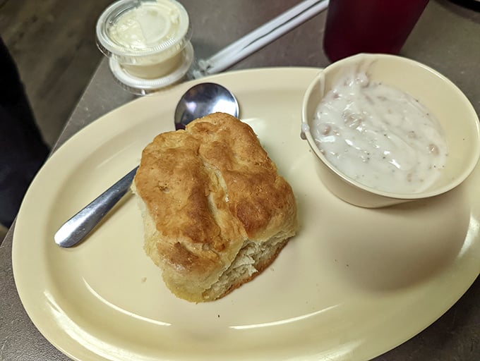 The humble biscuit and gravy—Southern diplomacy on a plate. Fluffy, buttery architecture supporting a creamy ambassador of comfort.