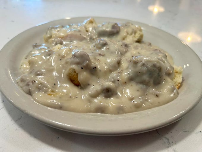Biscuits drowning in creamy sausage gravy – the kind of comfort food that makes you want to hug the chef and take a nap simultaneously.