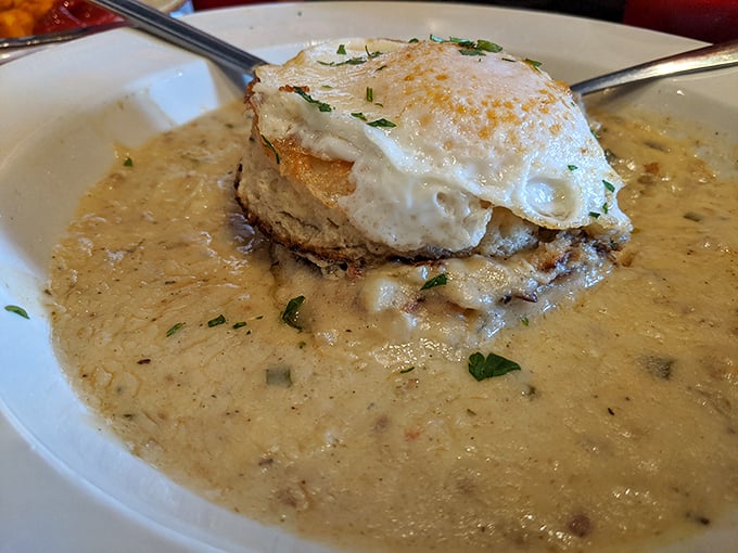 Biscuits swimming in a sea of sausage gravy with an egg island on top. Comfort food that requires both a fork and a nap afterward.