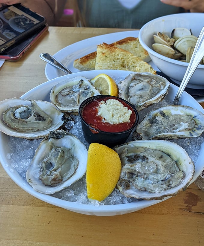 The ocean's perfect appetizer—fresh oysters on ice with lemon wedges standing by, ready for their moment of zesty glory.