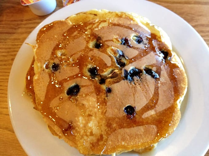 Blueberry pancakes that look like they're auditioning for a breakfast cereal commercial – golden, fluffy, and studded with berries that burst with every bite.