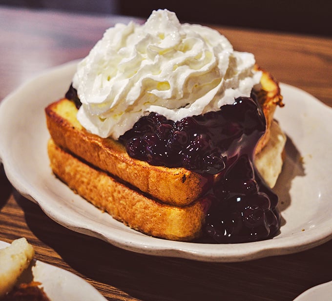 Blueberry-stuffed French toast crowned with whipped cream—where breakfast crosses into dessert territory and nobody's complaining.