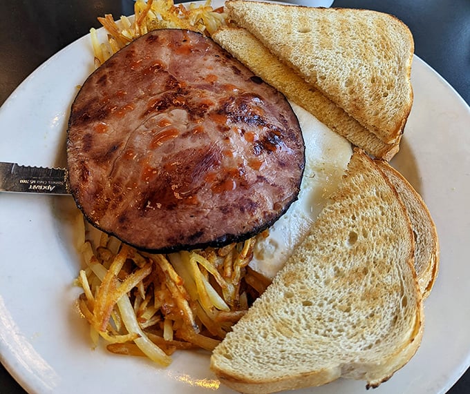 A breakfast platter that means business. That ham steak isn't messing around, and the toast stands ready for whatever you decide to pile on it.