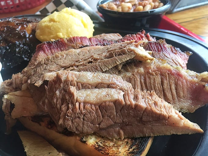 This brisket slice showcases that coveted smoke ring like a championship trophy demanding immediate attention.