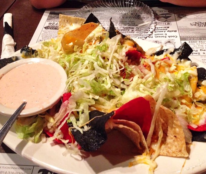 These nachos have more layers than a Pennsylvania winter wardrobe. Each bite delivers a perfect balance of crunch, spice, and creamy goodness.