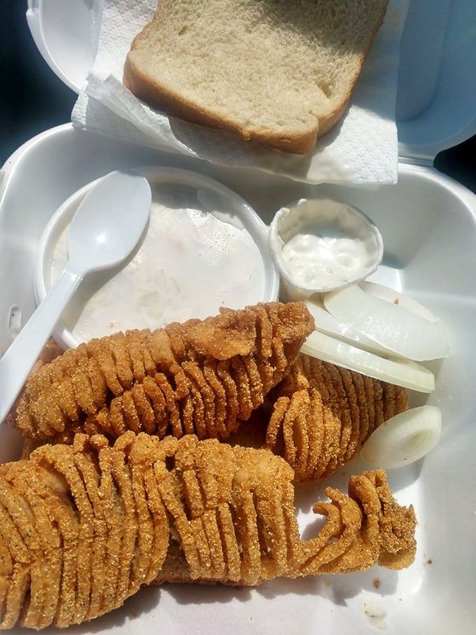 Scored Buffalo fish—a river delicacy that's wild-caught and cornmeal-crusted to perfection. The distinctive scoring pattern ensures even cooking and maximum flavor absorption.