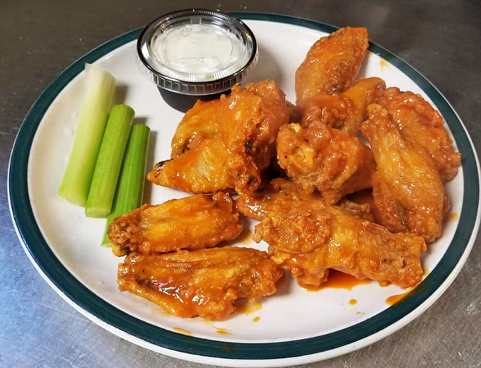 These buffalo wings aren't playing around—they're the kind that make you contemplate whether napkins were mankind's greatest invention. 