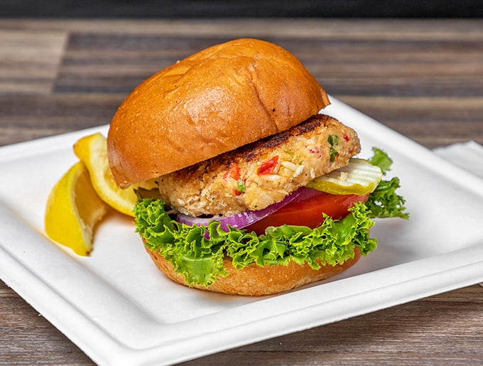 A crab cake sandwich that doesn't hide behind fancy aiolis or unnecessary frills—just fresh seafood, crisp veggies, and a bun that knows its role.