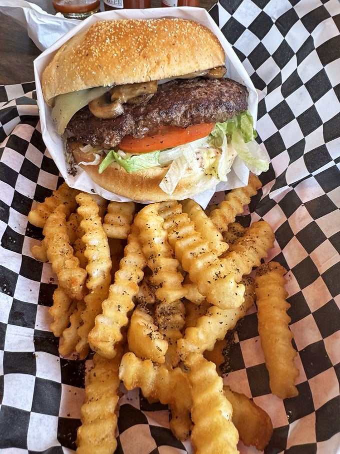 A burger that requires both hands and a strategy. Those seasoned crinkle fries aren't just a side dish—they're part of the conversation.