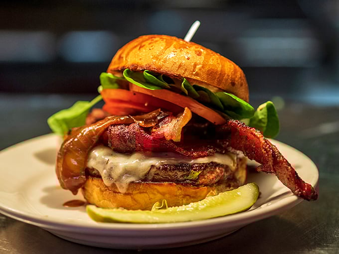 The famous Redcoat burger arrives like a beautiful, towering sculpture – a testament to beef artistry topped with melty cheese and crisp vegetables.