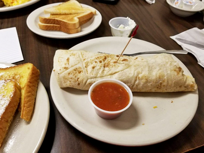 A breakfast burrito that looks like it means business—tortilla bronzed to perfection, stuffed with promise, and ready to fuel your Fort Worth adventures.