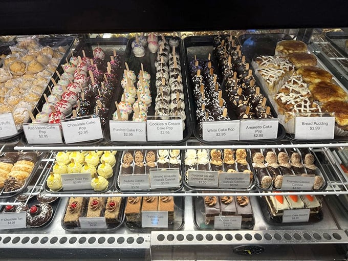 The display case—where diet plans go to die happy deaths and birthday resolutions are forgotten in chocolate-dipped bliss.